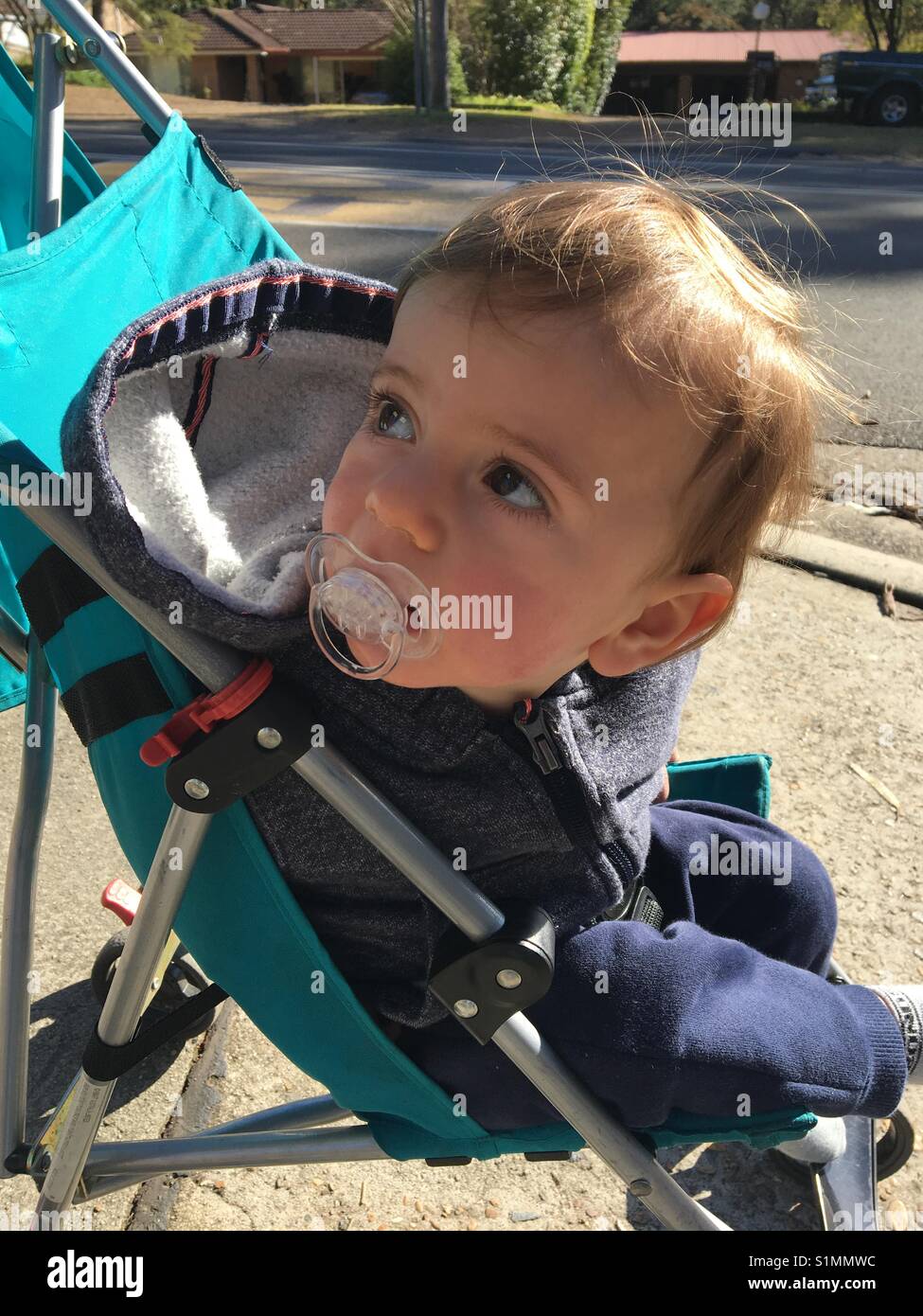 Boy in stroller Stock Photo - Alamy