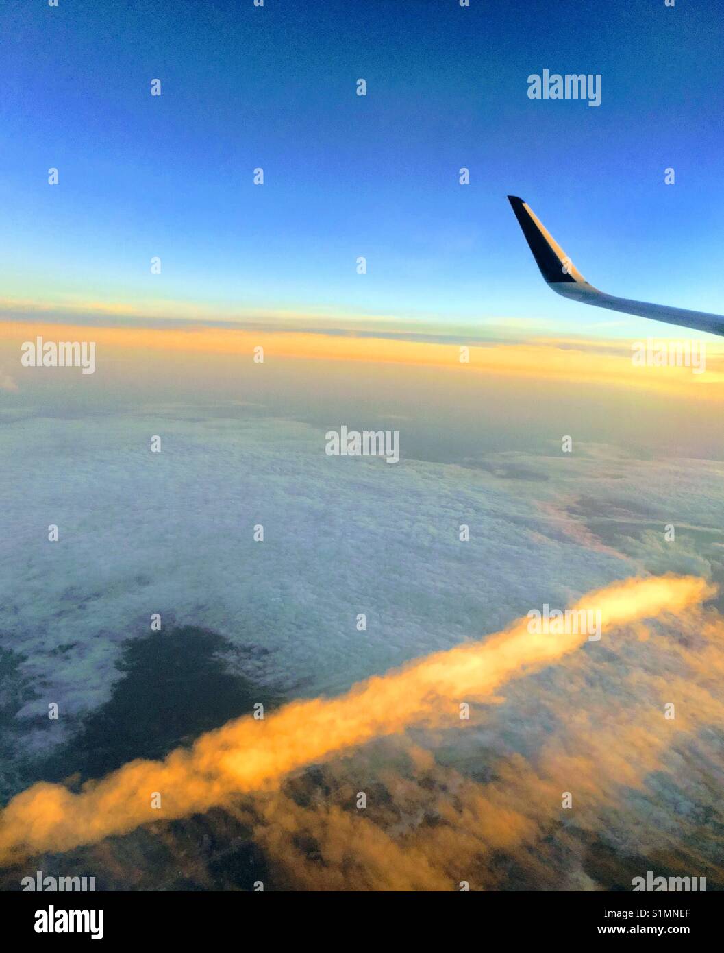 Sunset from Airplane over midwest USA, clouds and wing of plane Stock ...