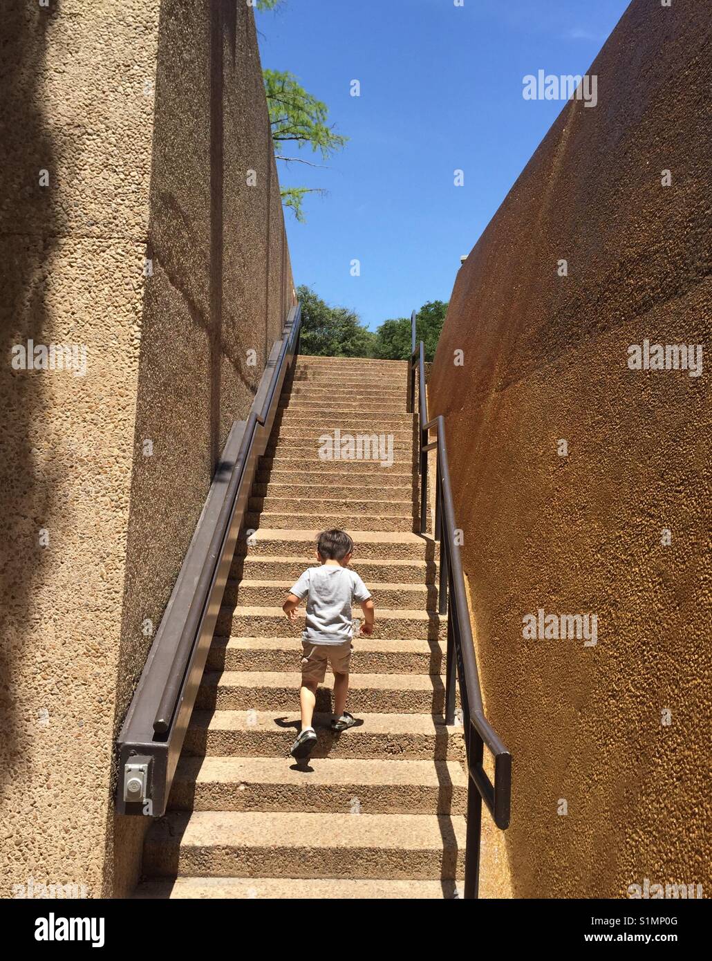 Boy running up stairs hi-res stock photography and images - Alamy