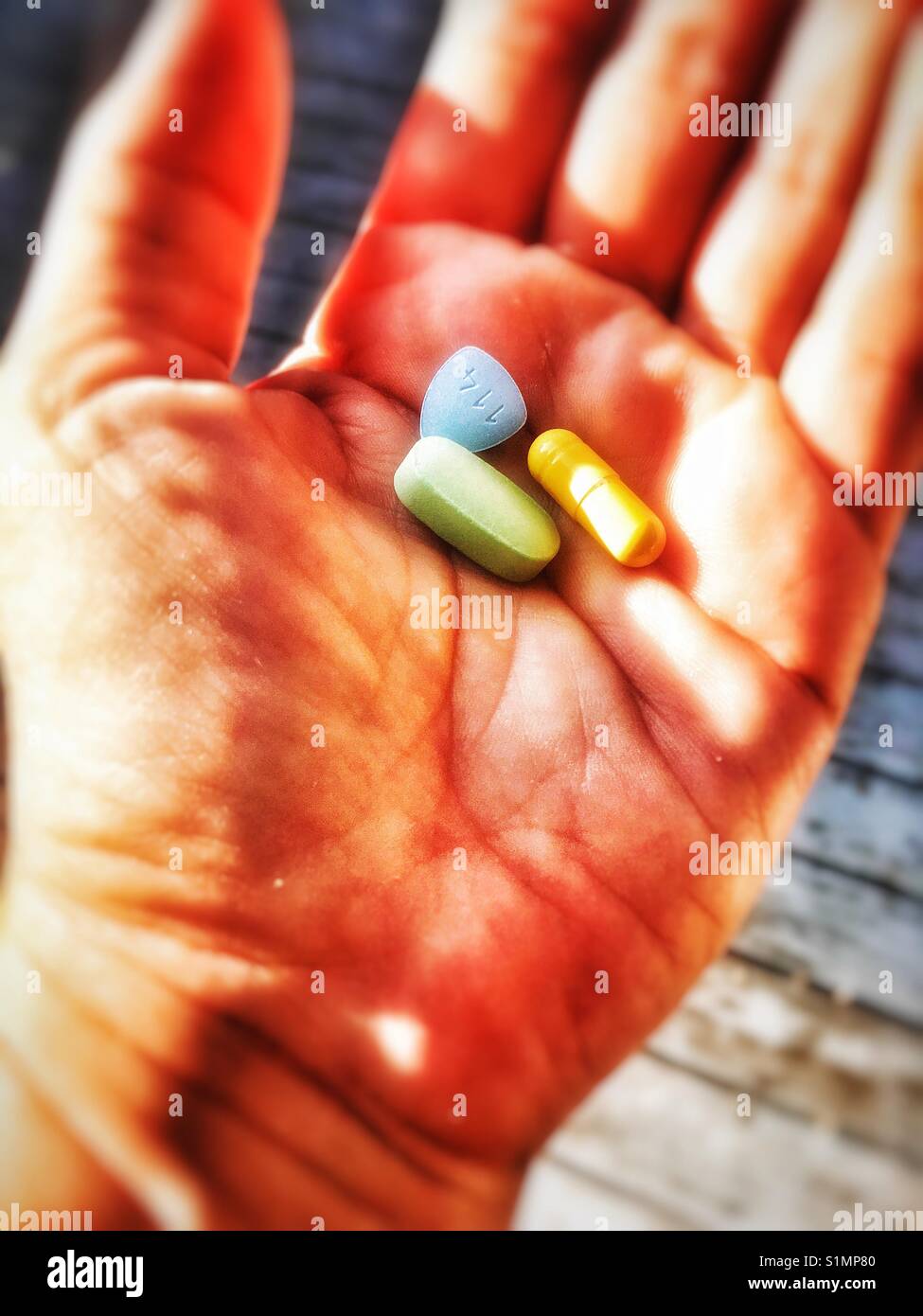 A hand with pills; fibromyalgia Stock Photo - Alamy