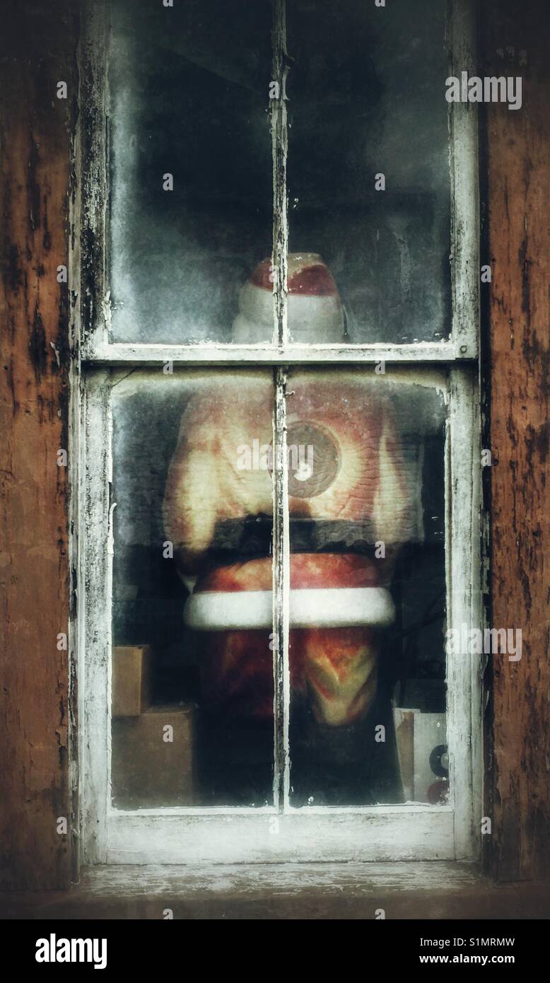 Large plastic Santa Claus decoration behind old window Stock Photo - Alamy