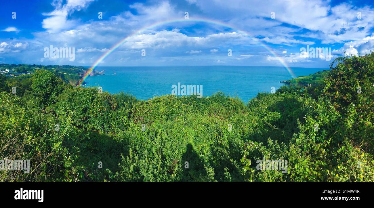 Beautiful rainbow on a sunny and cloudy day in brixham, Devon Stock ...