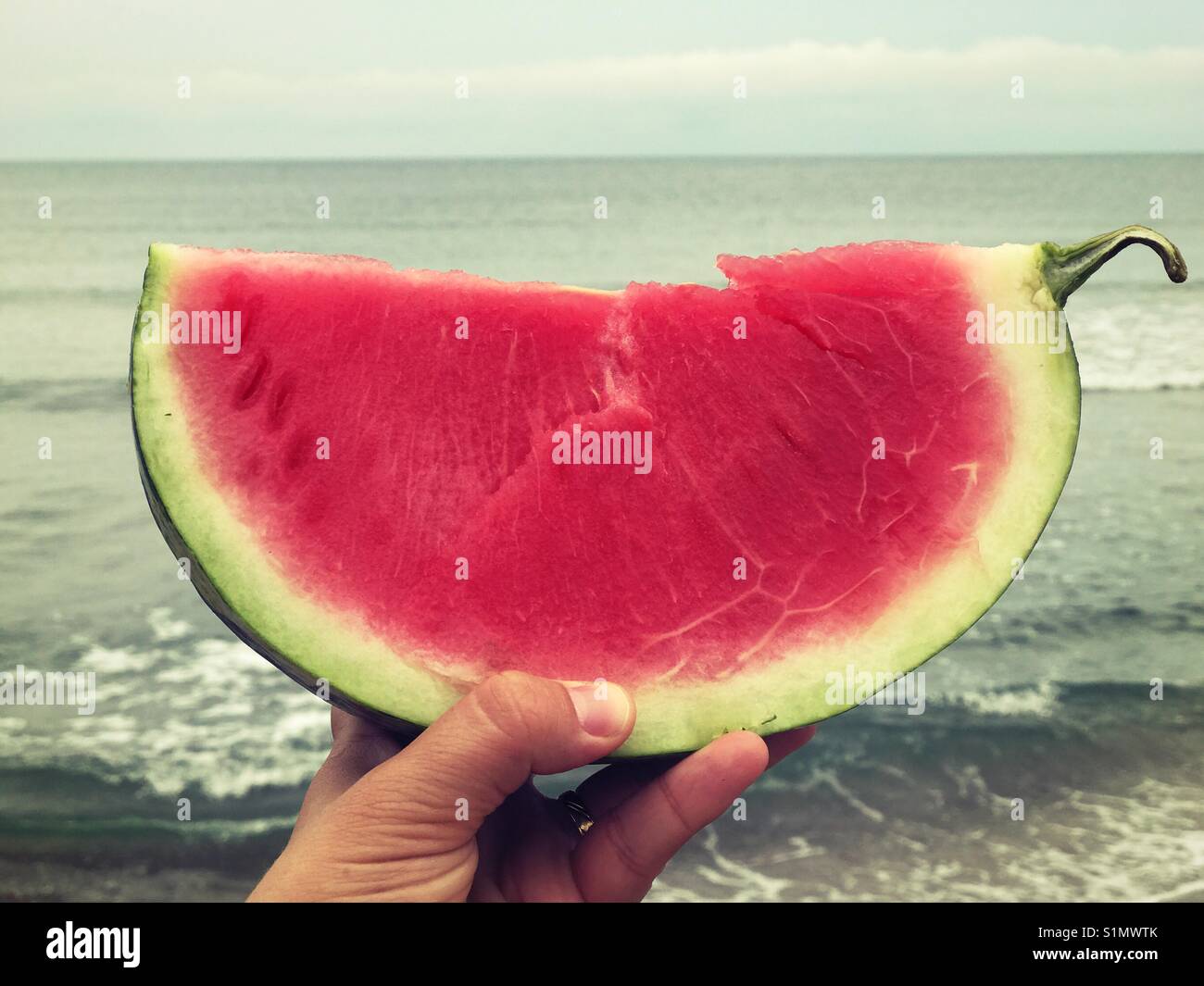 Eating watermelon on the beach Stock Photo - Alamy