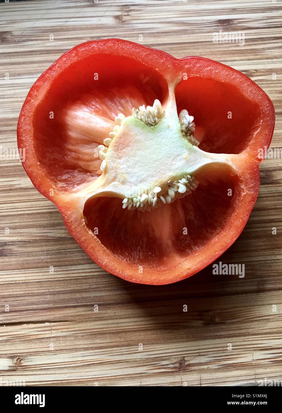 Red bell pepper cut in half showing it's inside seeds and flesh Stock ...