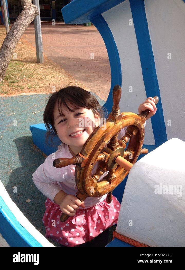 Cute little girl at the ships wheel Stock Photo - Alamy