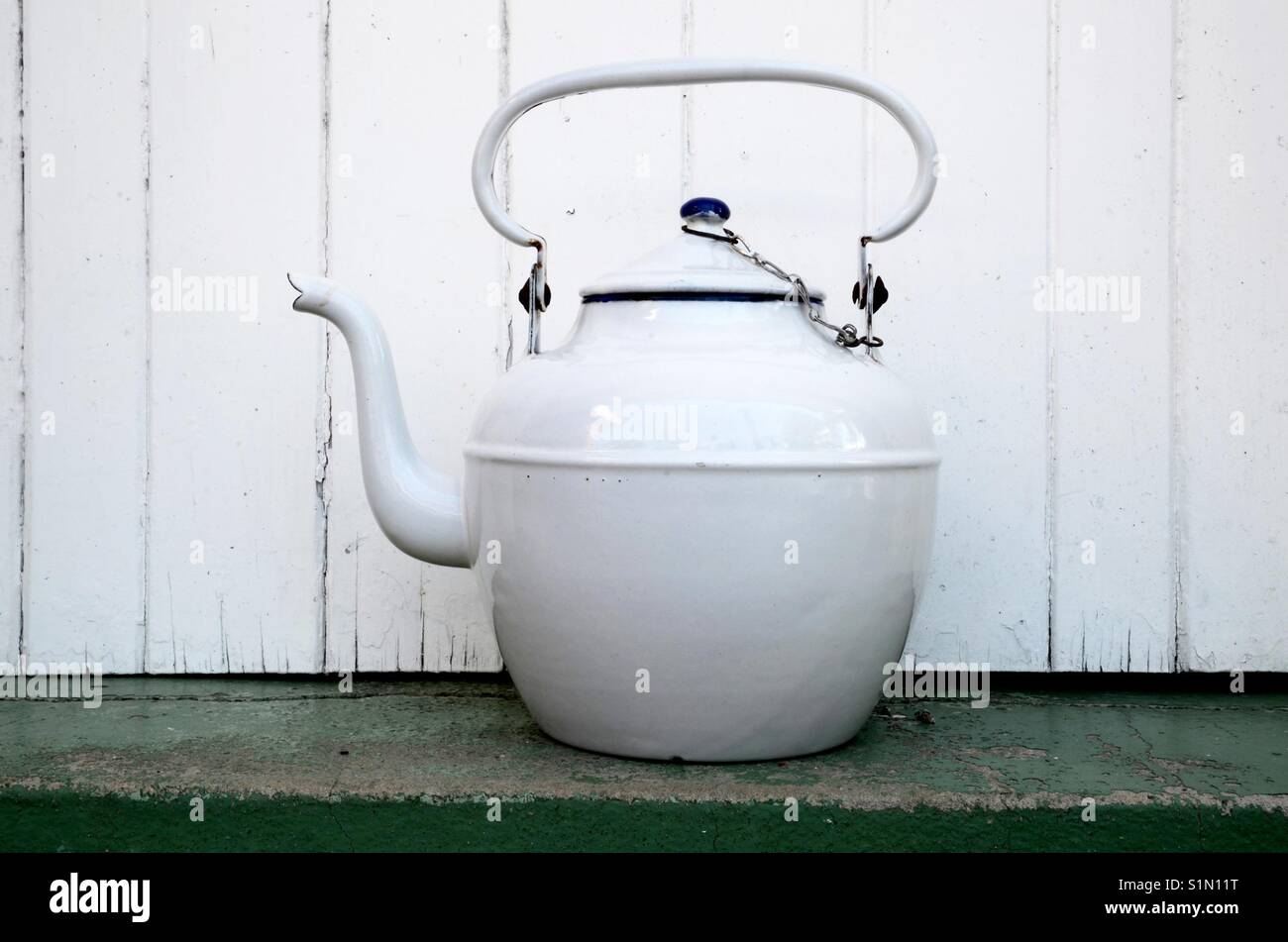 A white vintage enamel kettle Stock Photo - Alamy