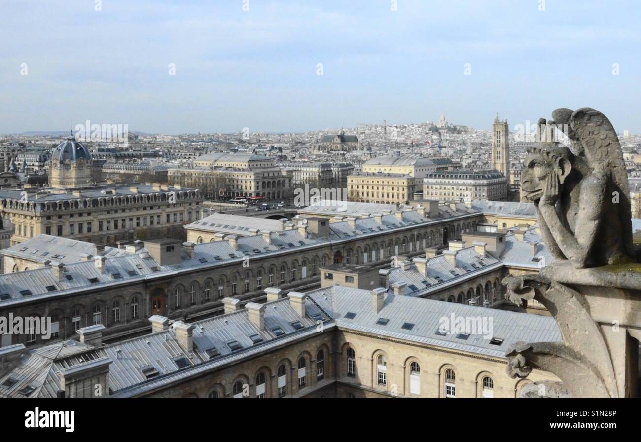 Bored Statue watching over Paris Stock Photo - Alamy