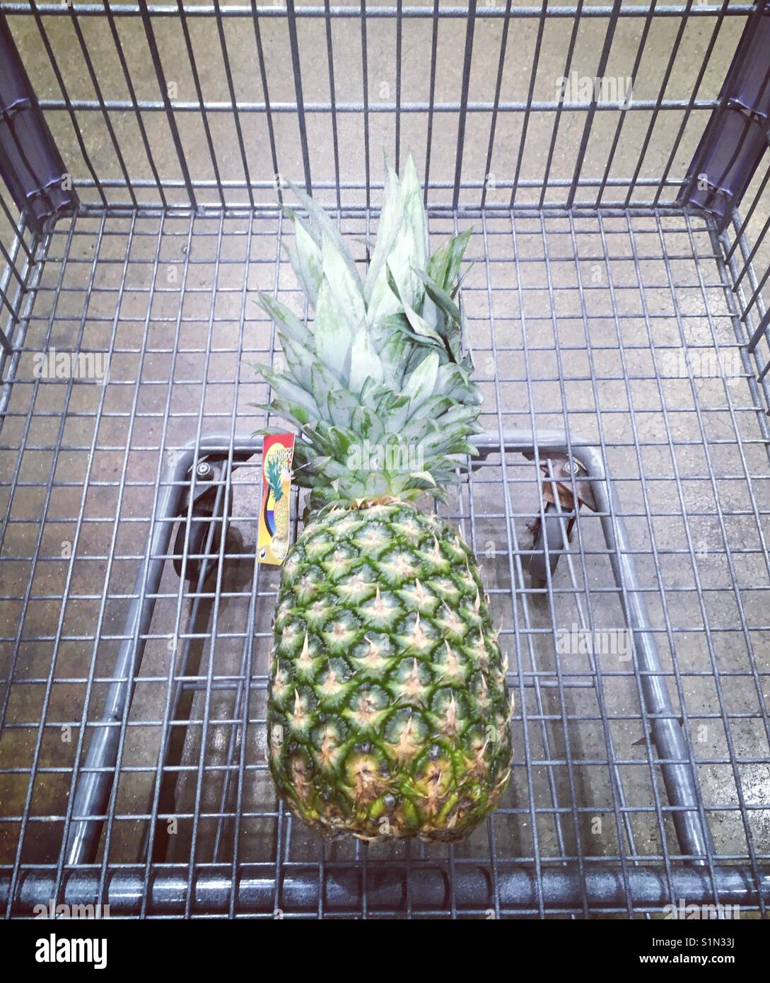 Pineapple fruit in a supermarket shopping trolley Stock Photo - Alamy