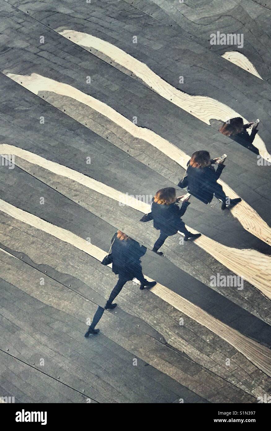 Person walking reflected on hi-res stock photography and images - Alamy