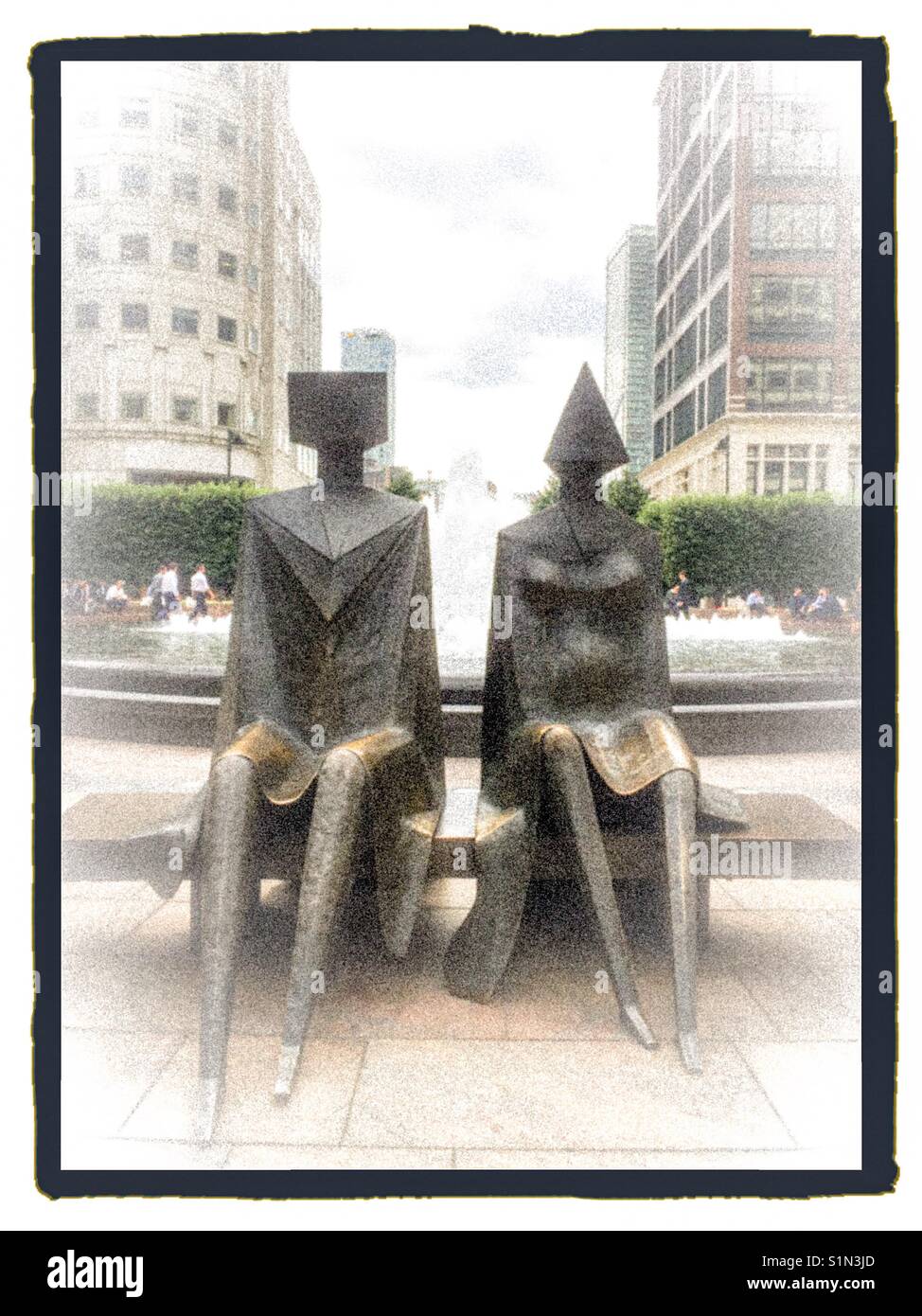 Pair of statues sitting on bench at Canary Wharf in London Stock Photo ...