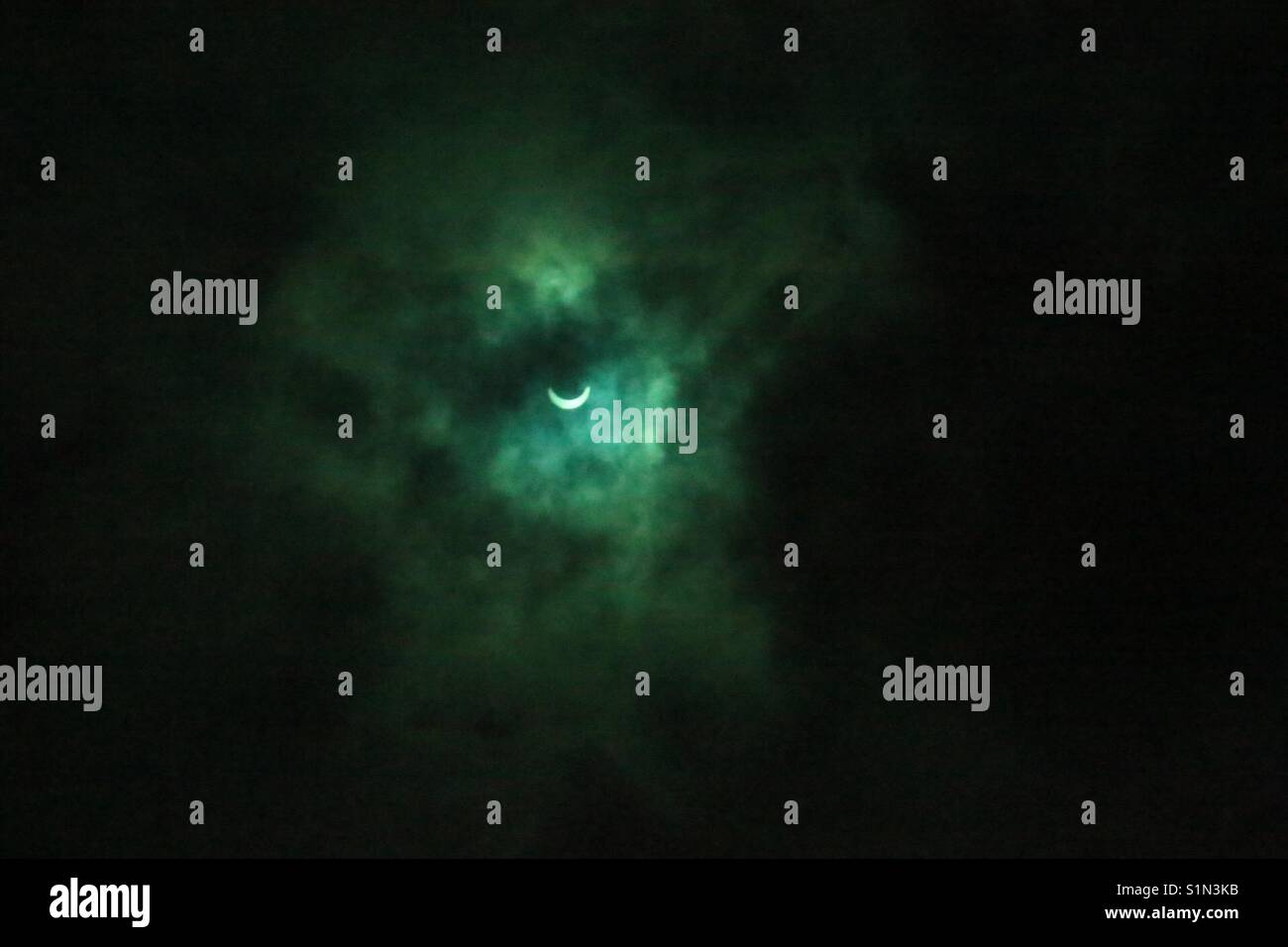 Solar eclipse snapped through a welding mask. Green tint makes the ...