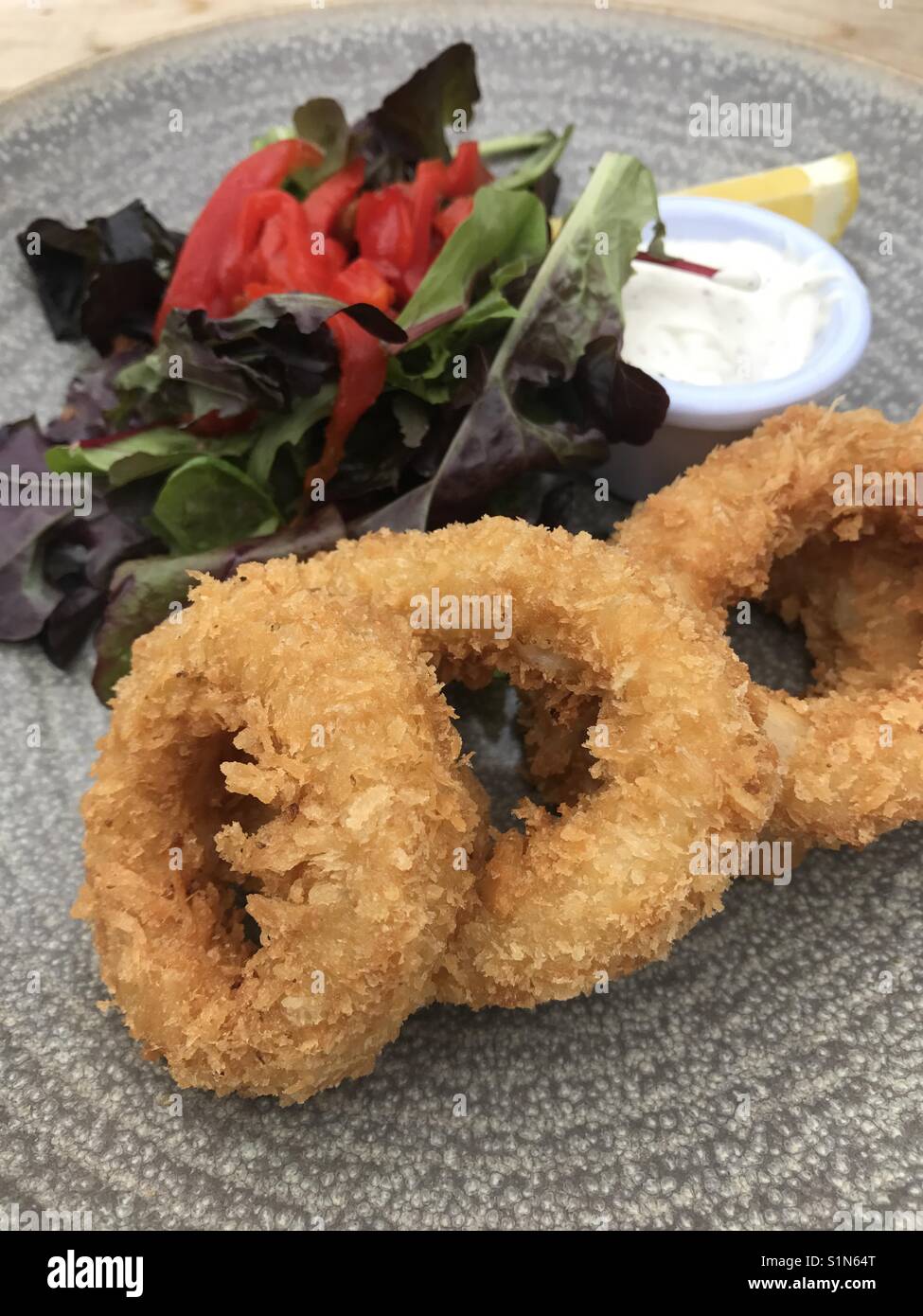 Calamari rings in panko breadcrumbs Stock Photo - Alamy