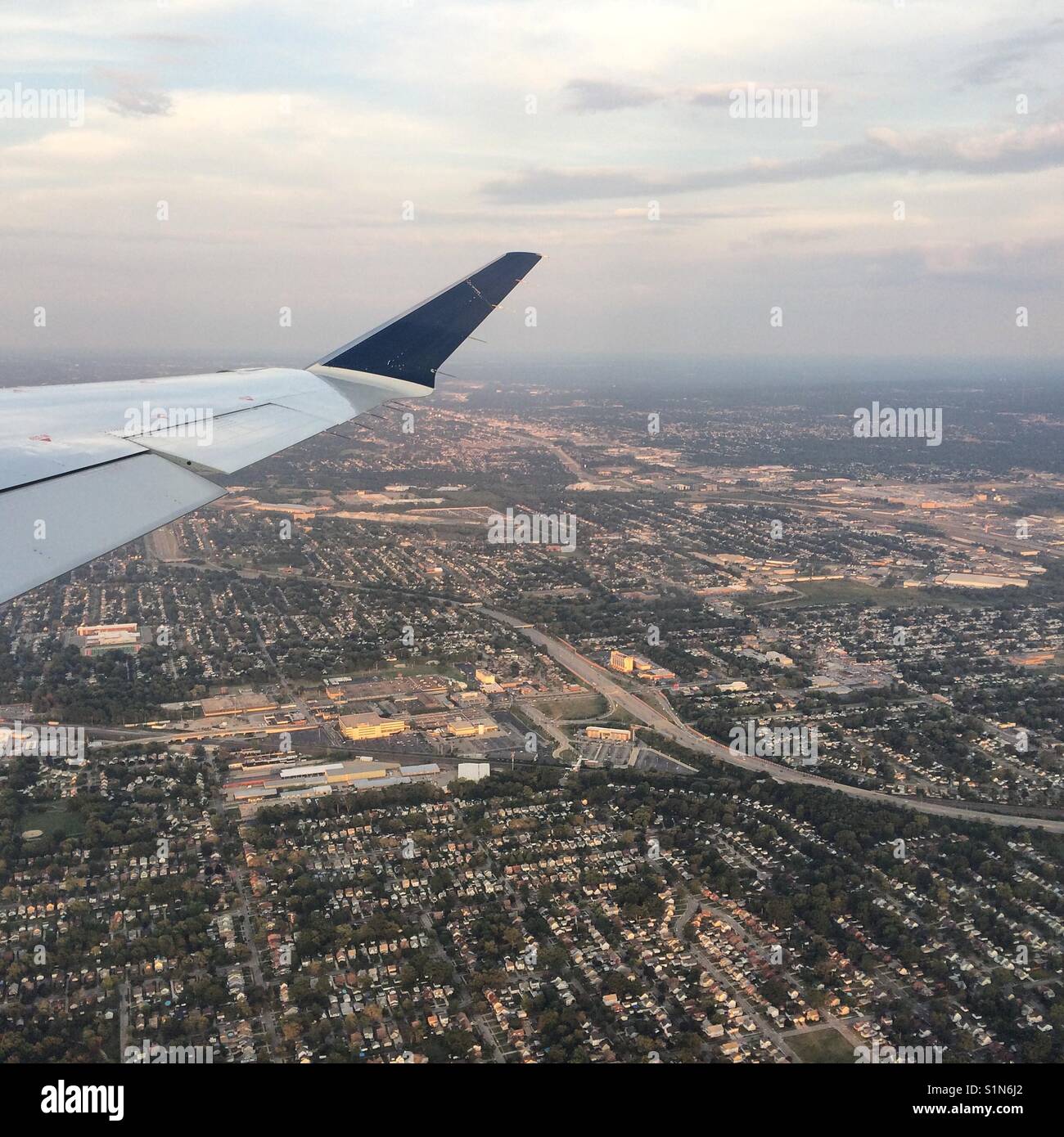 Airplane wing over landscape Stock Photo - Alamy