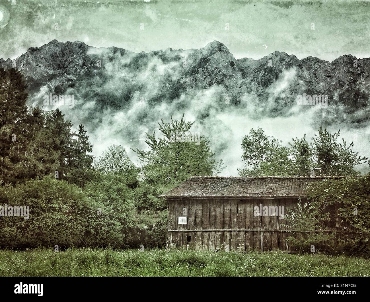Old Barn against a cloudy mountain background Stock Photo - Alamy