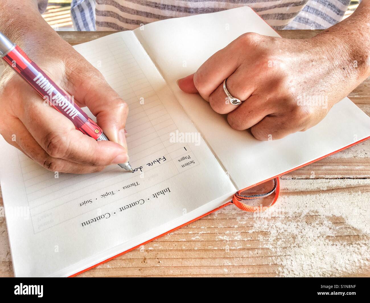 Woman writing in a bullet journal Stock Photo - Alamy