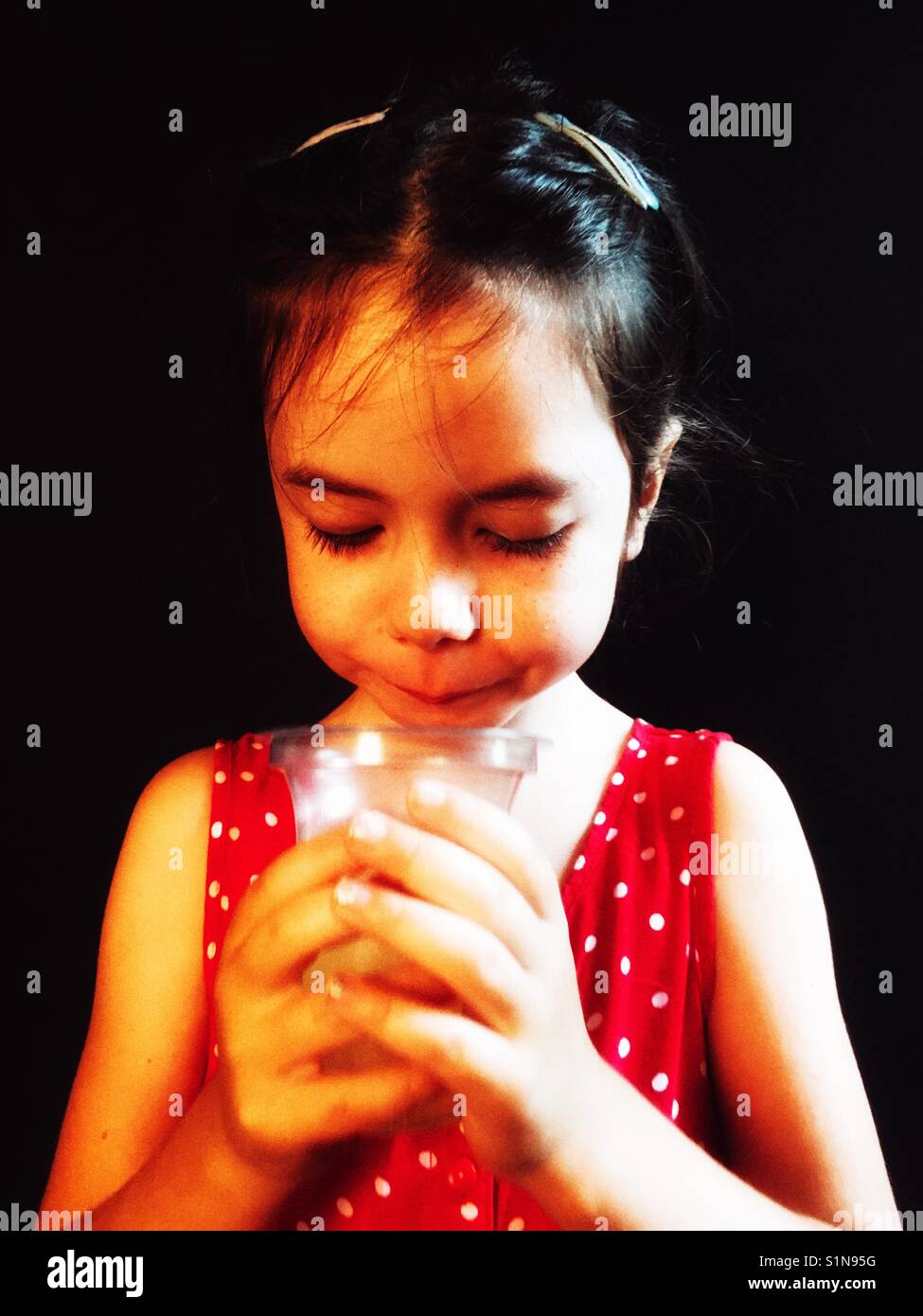 Child with beaker of orange juice Stock Photo - Alamy
