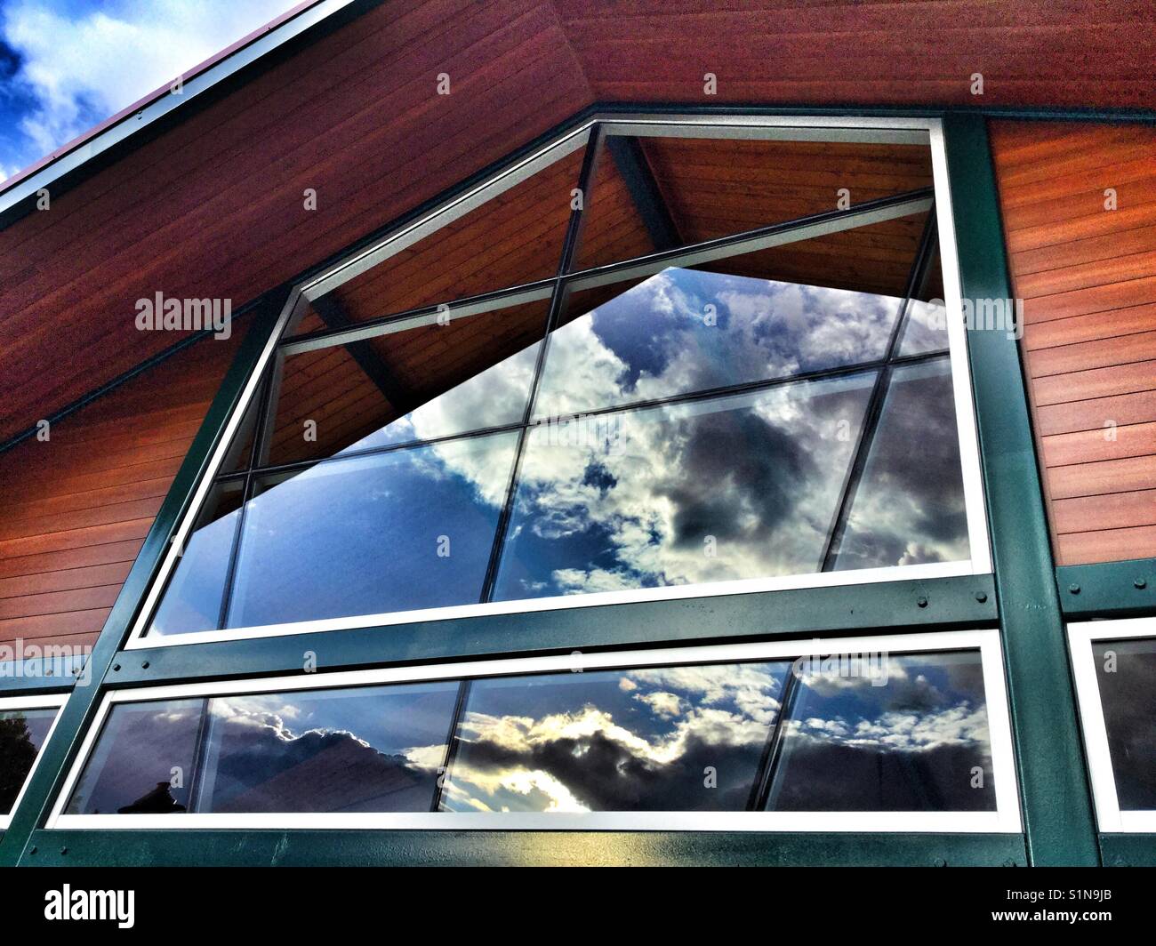 Clouds reflected in glass window Stock Photo - Alamy