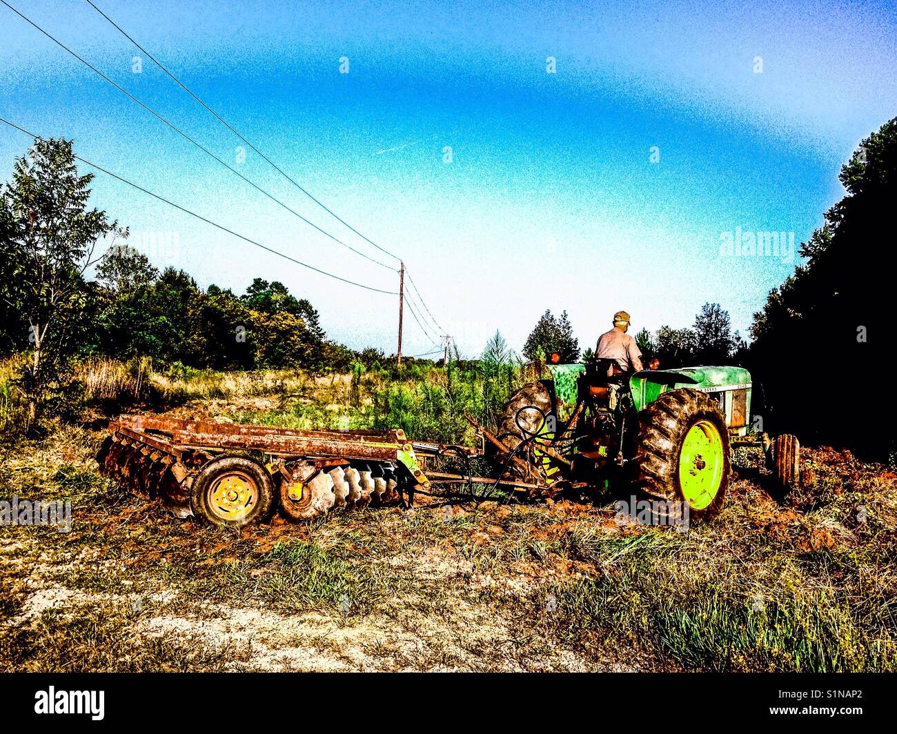 Tractor with disc harrow hi-res stock photography and images - Alamy
