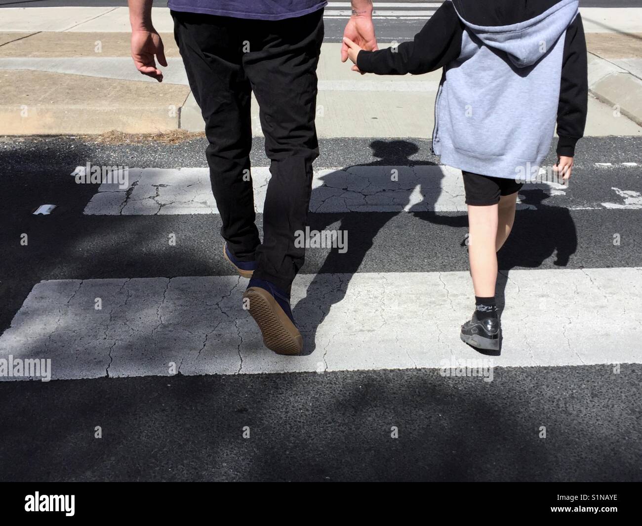Man walking across crosswalk hi-res stock photography and images - Alamy