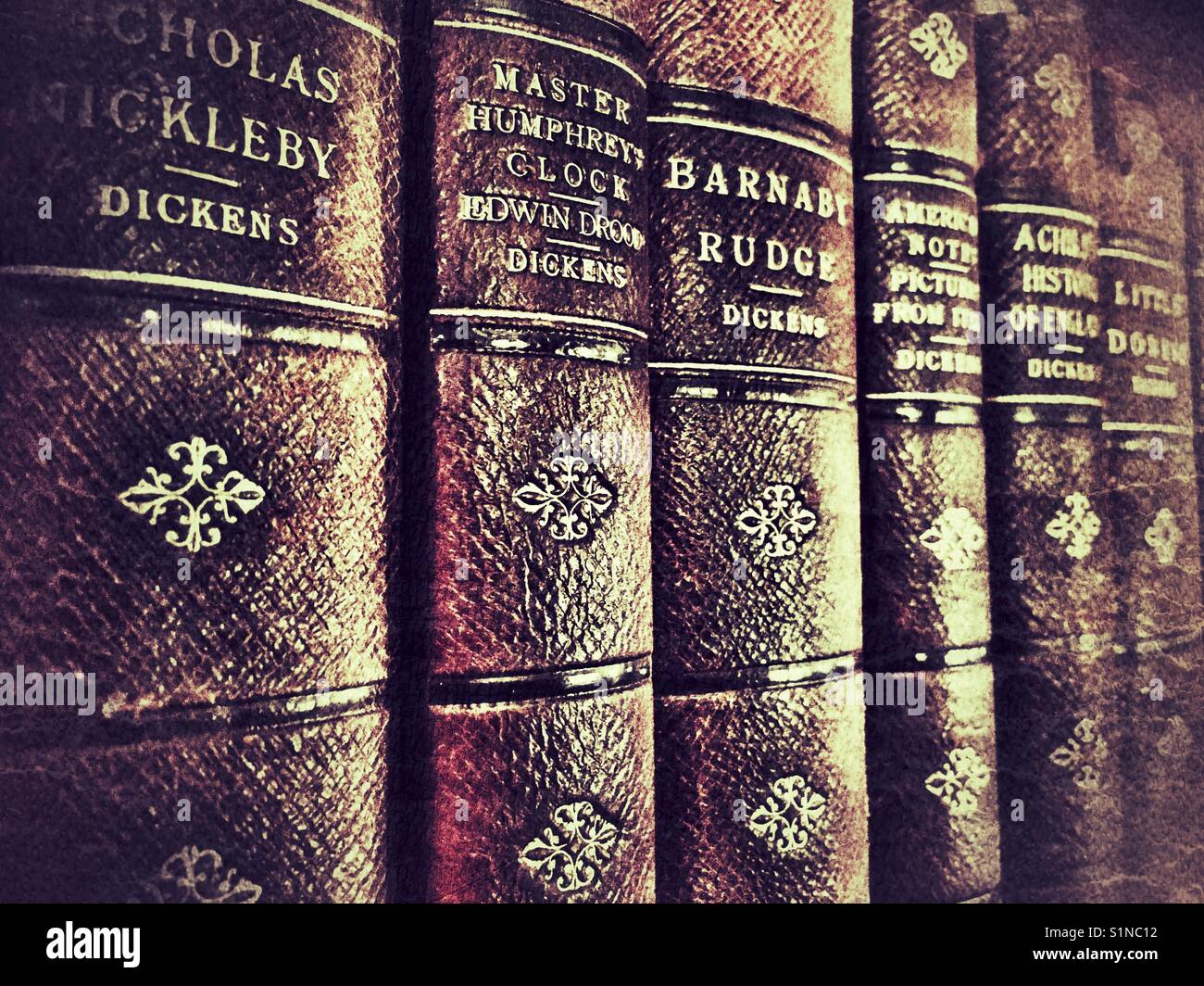 Antique books by Dickens, on a shelf in a bookcase Stock Photo - Alamy