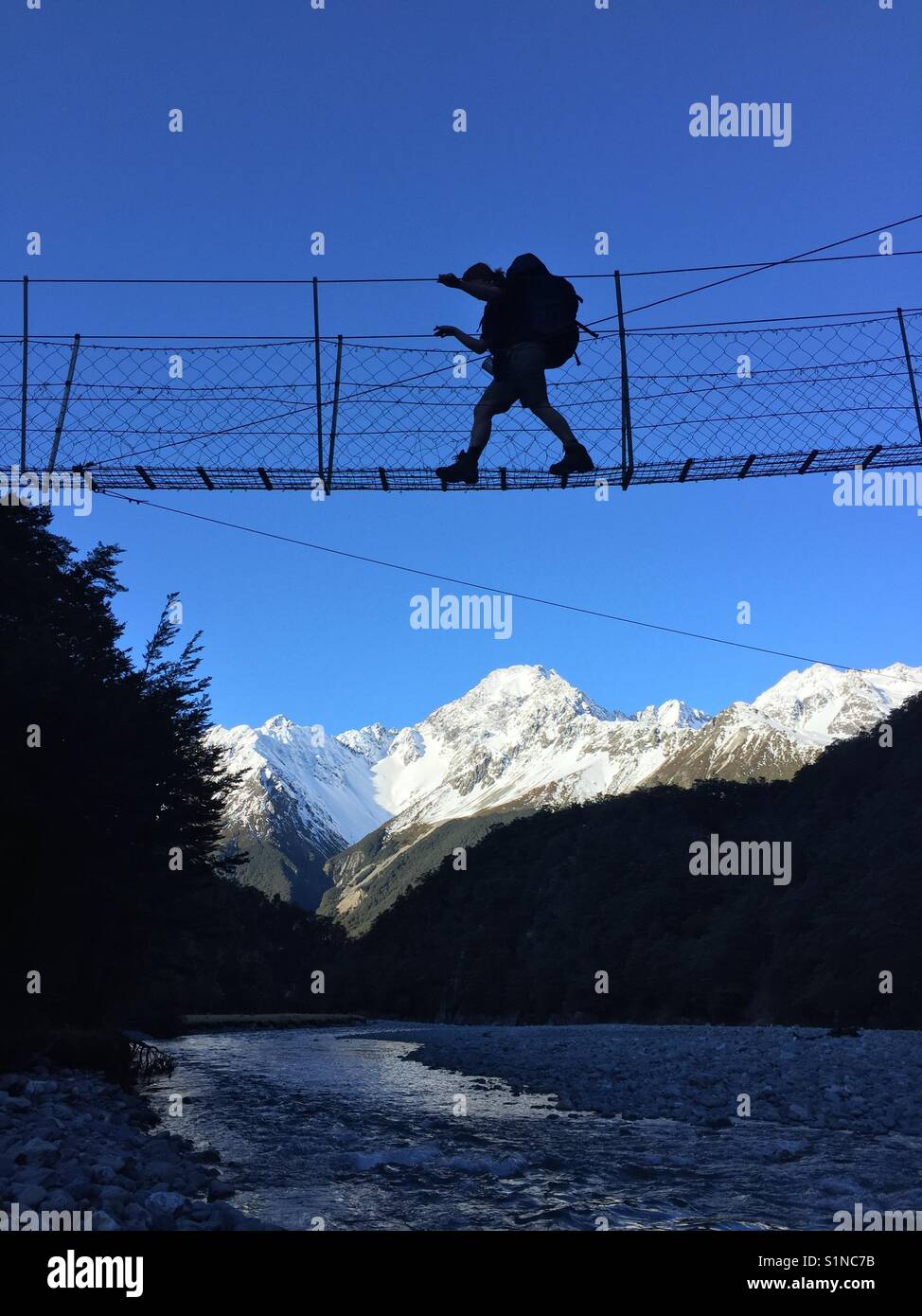 Crossing bridge whilst hiking Stock Photo - Alamy