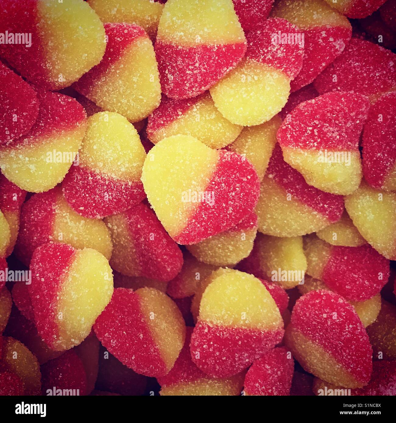 Heart shaped soft candies in yellow and red Stock Photo - Alamy