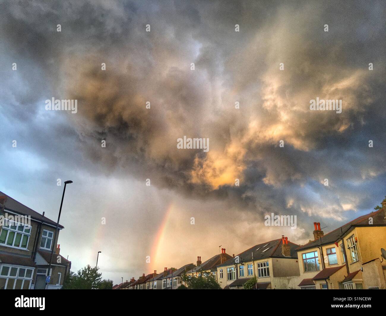 Rainbow and stormy sky Stock Photo - Alamy