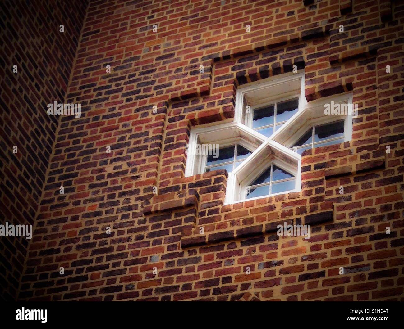 Cross shaped window in brick church Stock Photo - Alamy