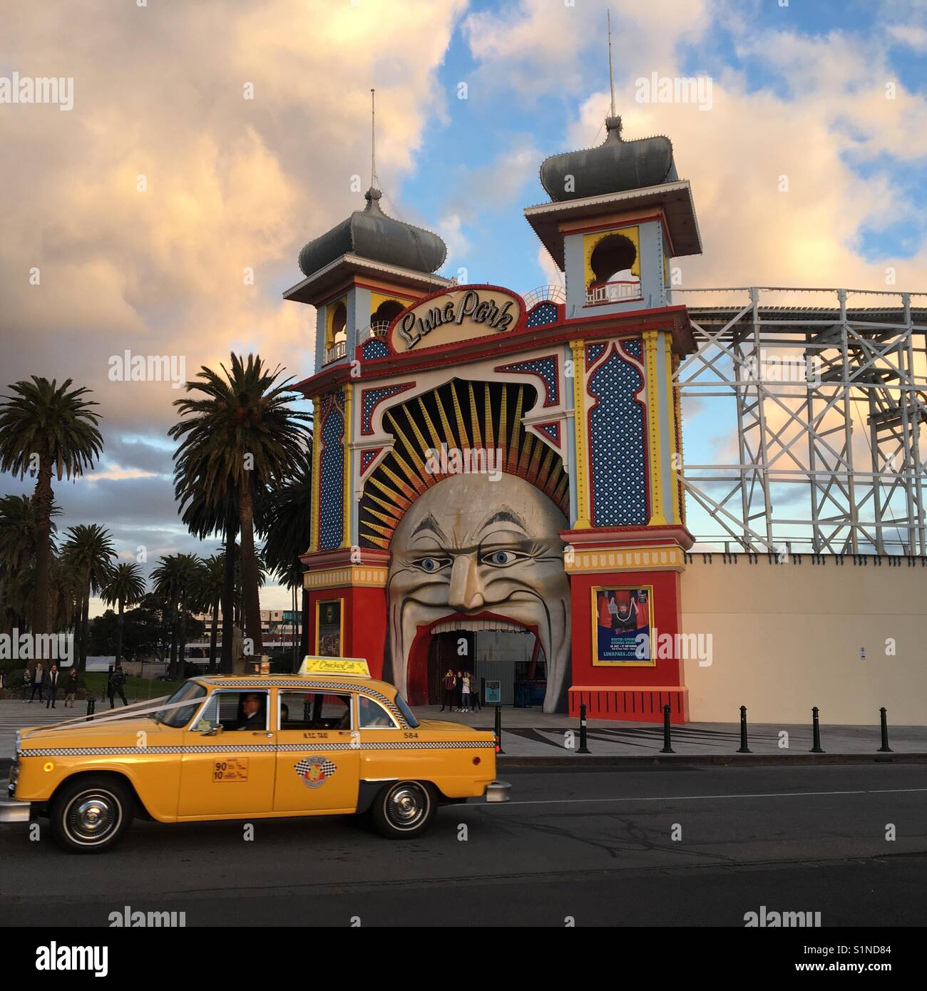 Old New York City taxi cab with a wedding party inside drives past Luna ...