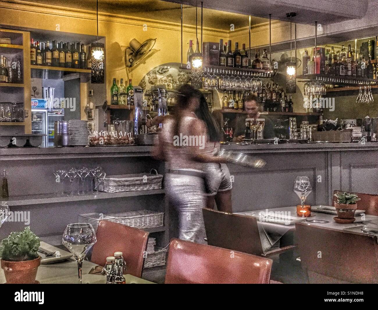 Restaurant interior - laid tables and the bar area with barman and ...