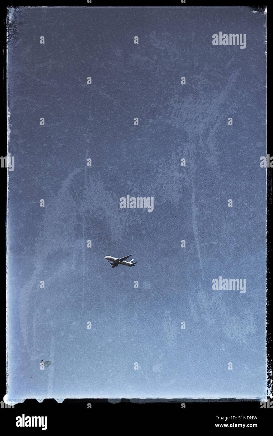Airplane flying up in sky with a dramatic frame Stock Photo - Alamy