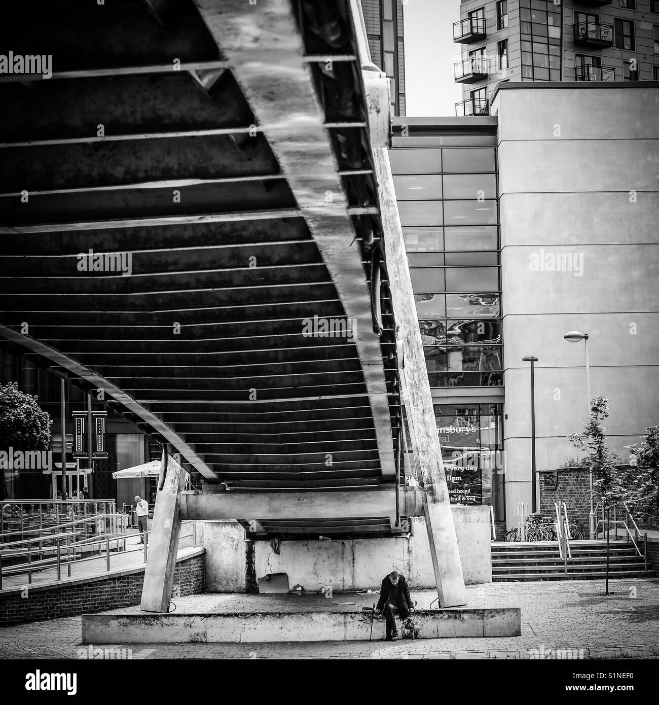 Man sat under a bridge in Leeds, West Yorkshire Stock Photo - Alamy