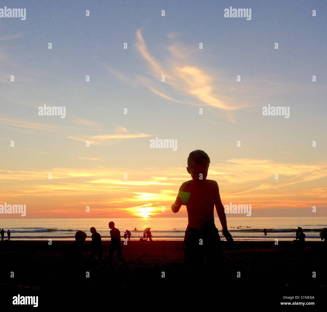 Boy at beach sunset hi-res stock photography and images - Alamy