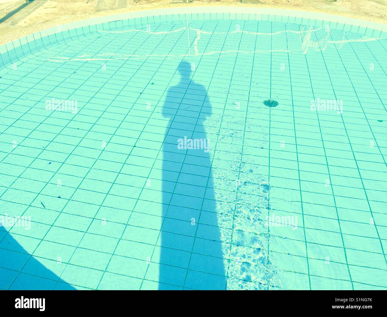 A person's shadow in a swimming pool taking photos Stock Photo - Alamy