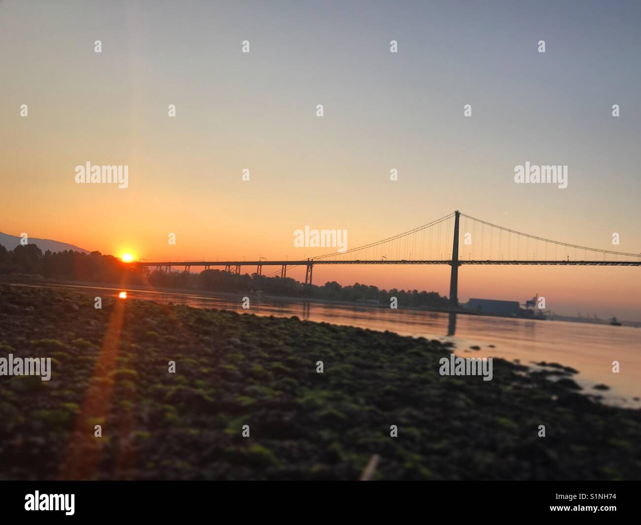 Sunrise over a bridge Stock Photo - Alamy