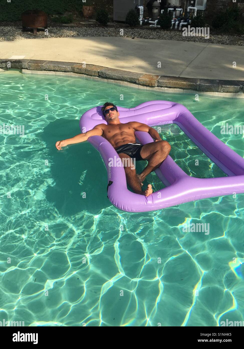 Man chilling in swimming pool hi-res stock photography and images - Alamy