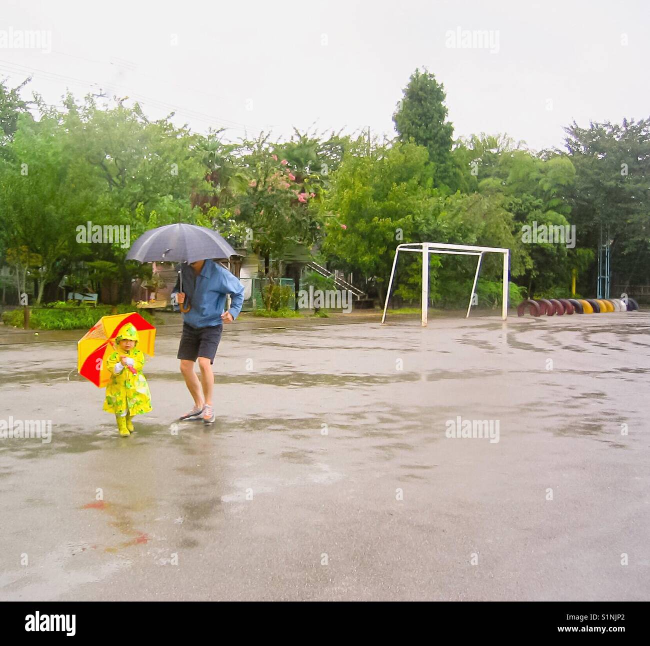 Rainy day puddle fun Stock Photo - Alamy