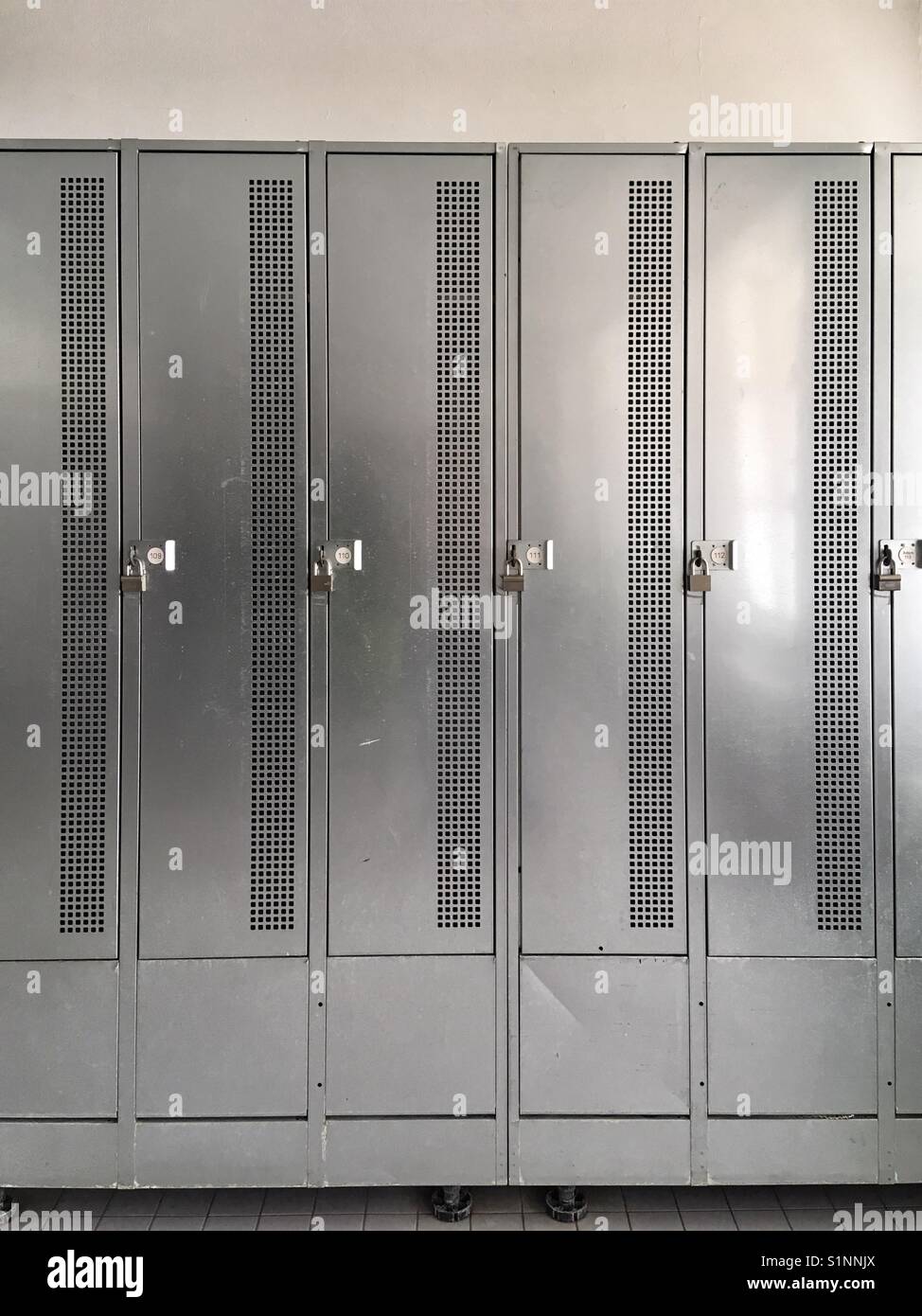 A row of silver steel lockers Stock Photo - Alamy
