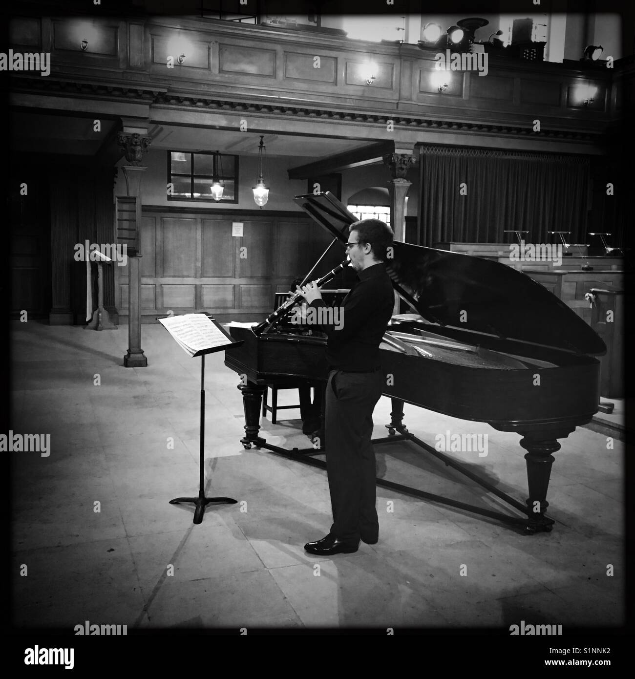 Clarinet player in church Stock Photo - Alamy