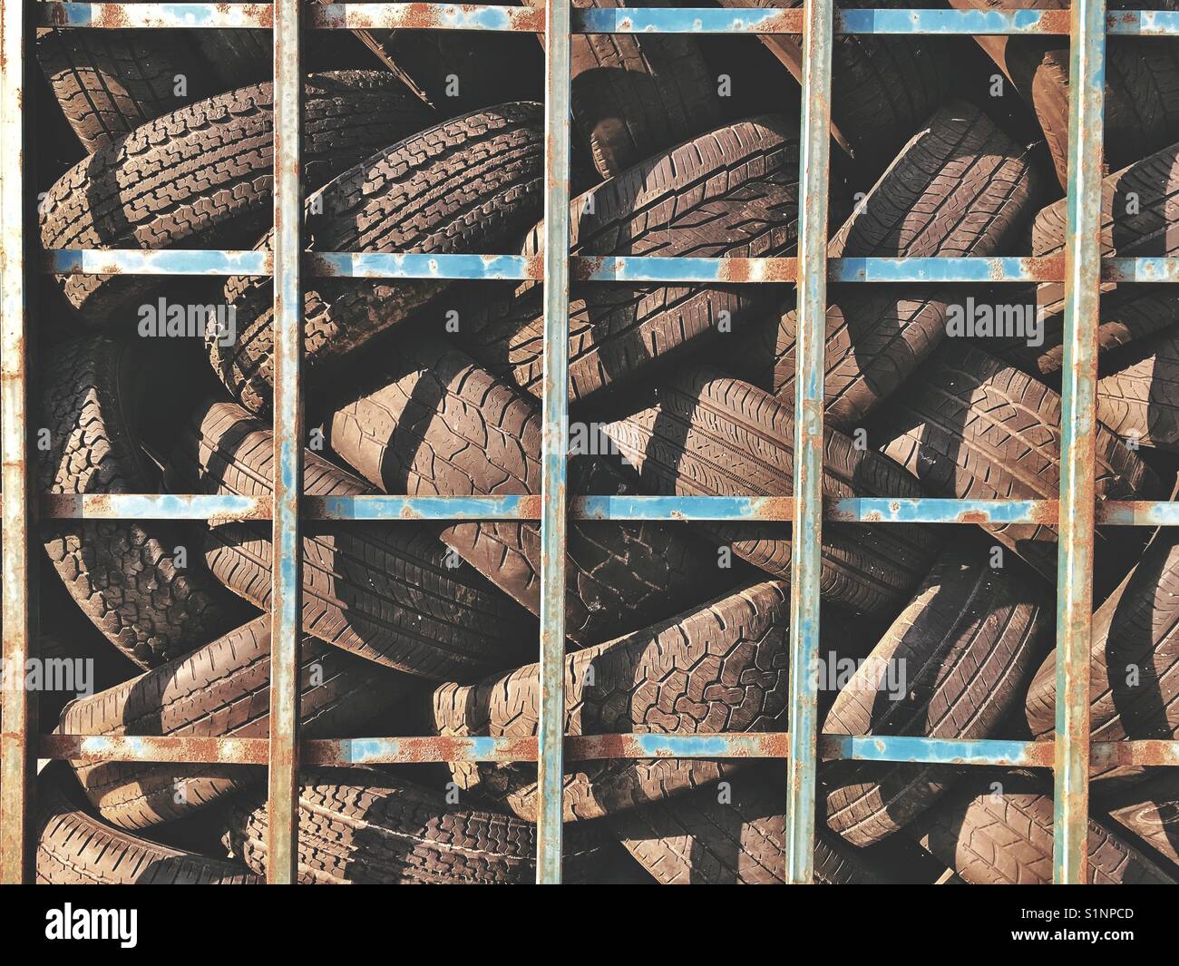 Pile of tires for recycle in a metal cube Stock Photo - Alamy