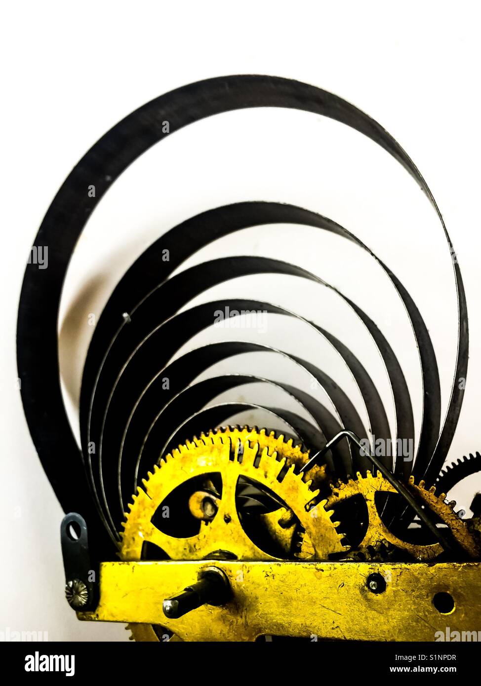 Gears and uncoiled spring Stock Photo - Alamy