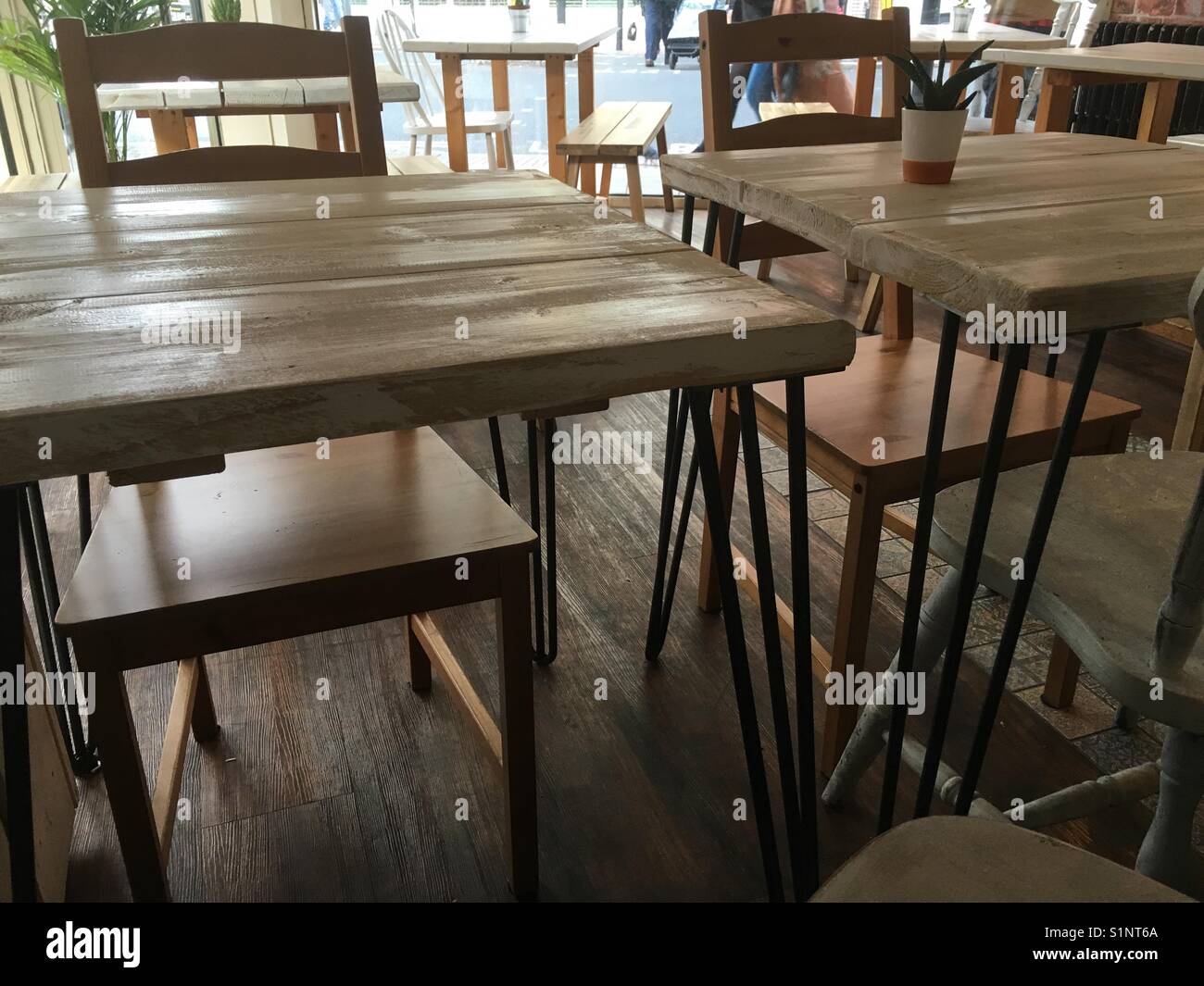 Wooden Tables close together at cafe Stock Photo - Alamy
