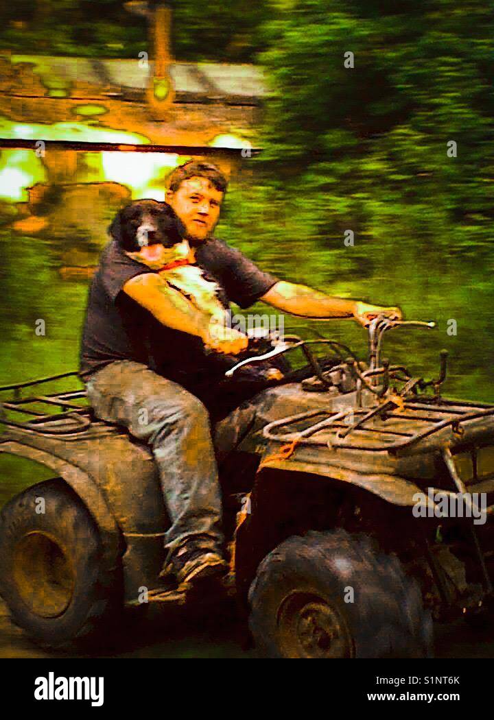 A boy and his dog... Riding an ATV Stock Photo - Alamy