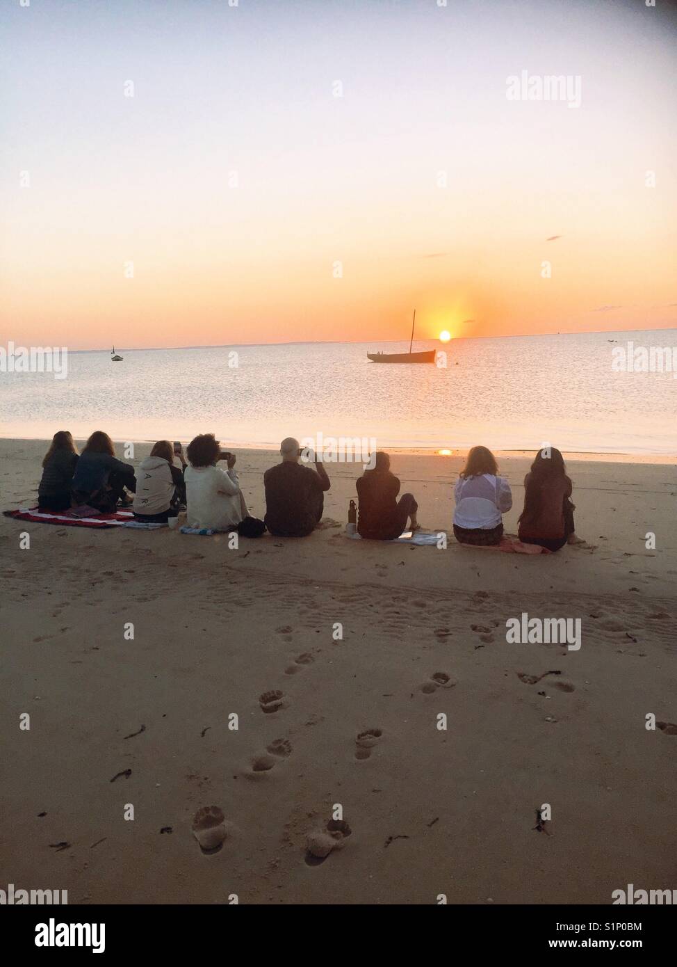Group of sunrise watchers on the beach in Mozambique Stock Photo - Alamy