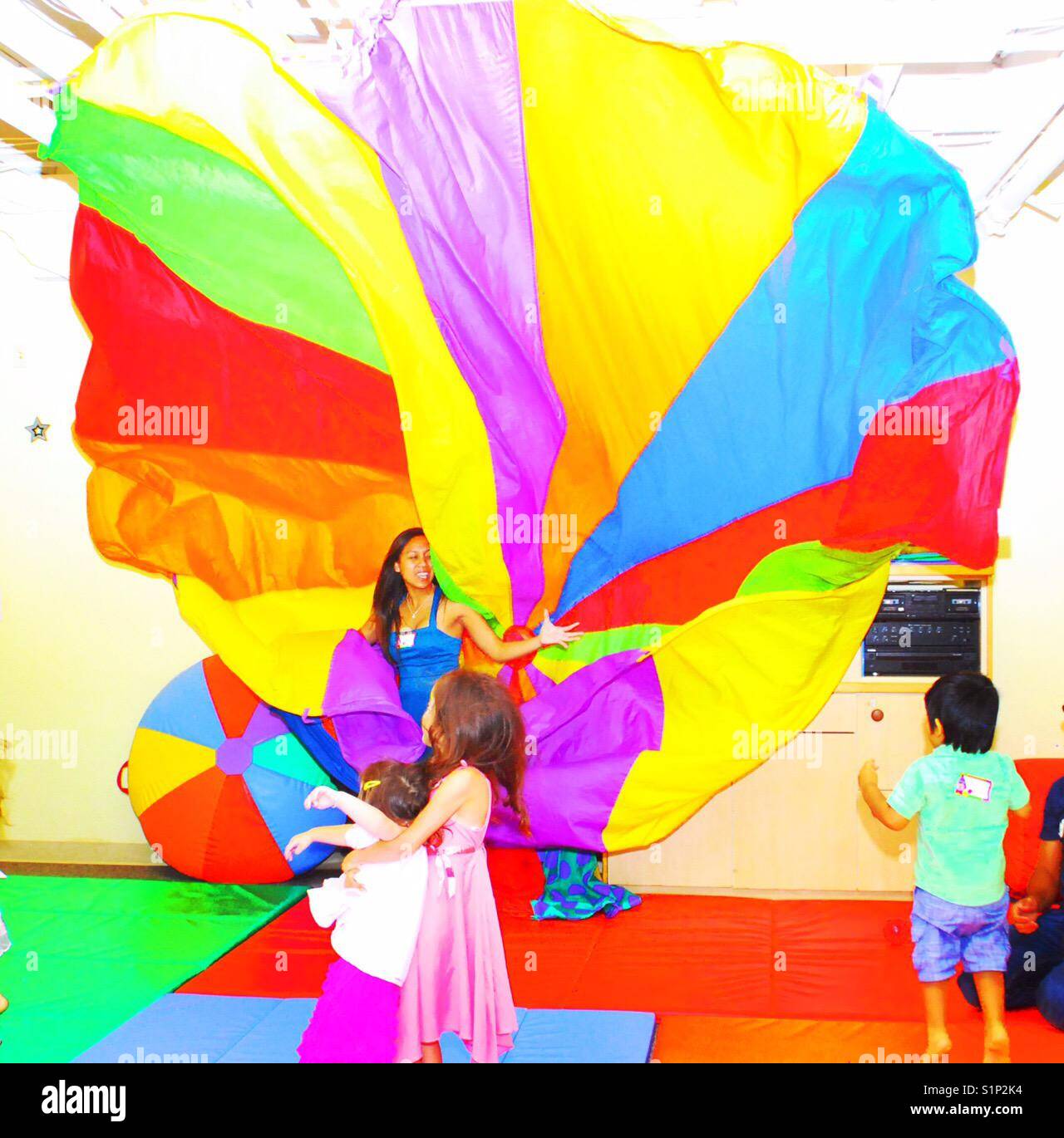 Rainbow play parachute hi-res stock photography and images - Alamy