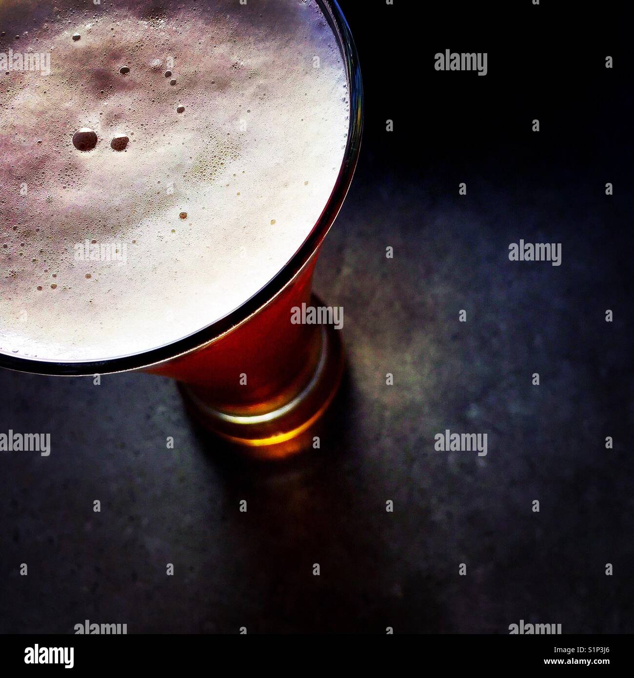 Close up overhead shot of a pint of beer on a concrete table top Stock ...