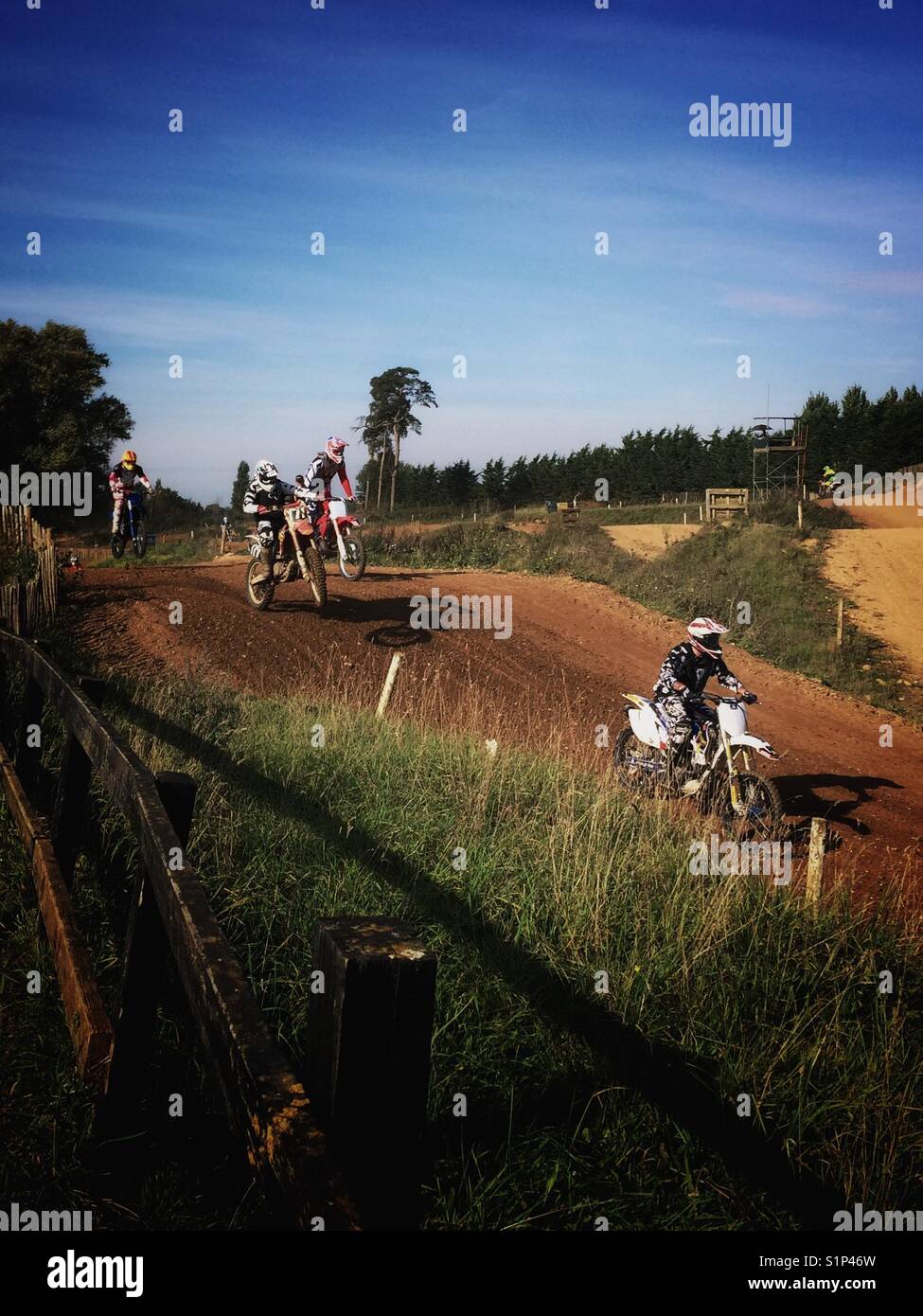 Trial bikes jumping over a hill Stock Photo - Alamy