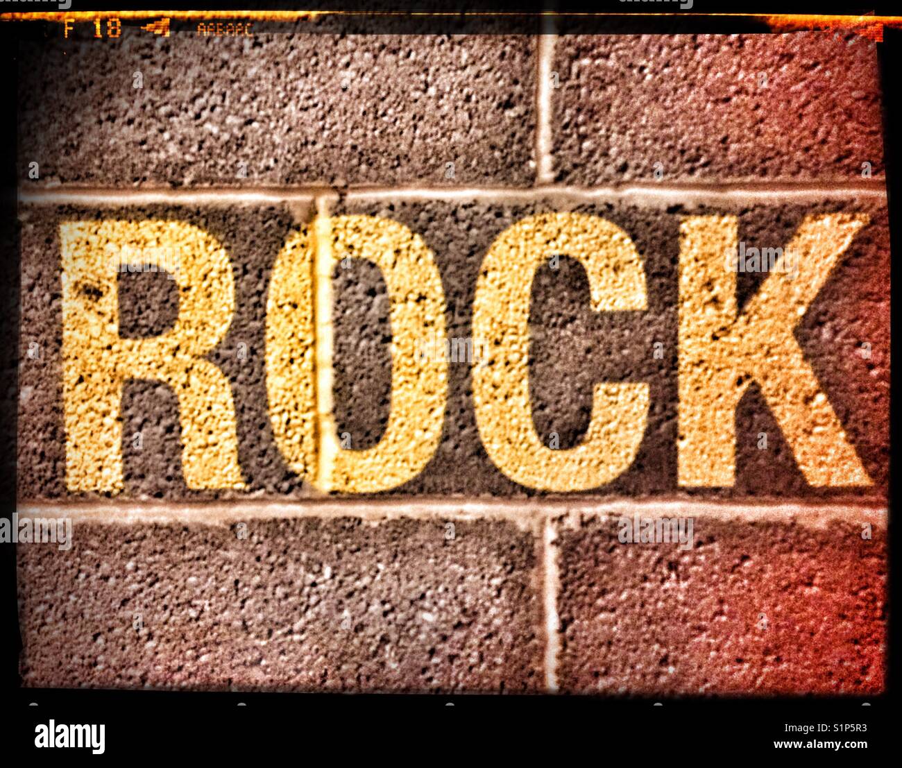Work rock on wall Stock Photo - Alamy