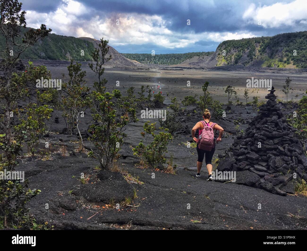 A female sets off to hike across the bottom of a volcano crater ...