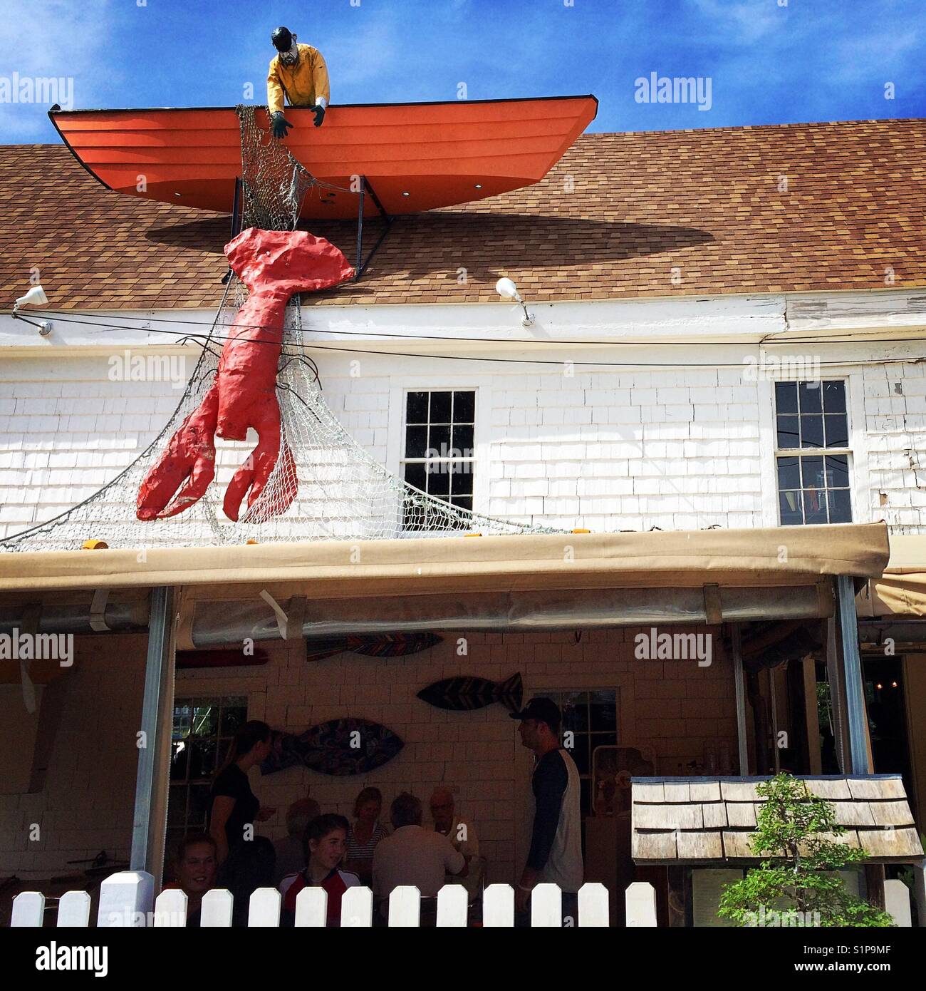 Decoration of a fisherman and a giant lobster on the roof of Mac's ...